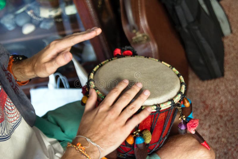 Hands of Man Playing African Drum or Djembe Inside a Music Shop. Stock ...