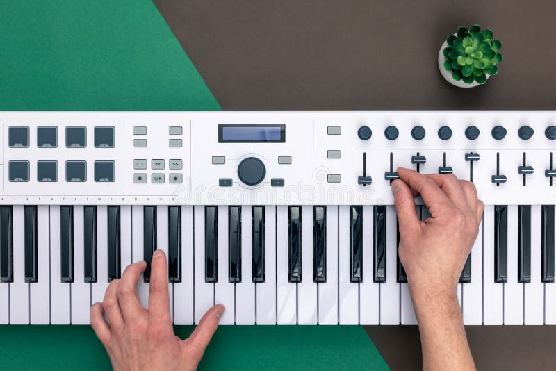 Hands of a Man Playing Musical Keys on a Colored Background, Flat Lay ...