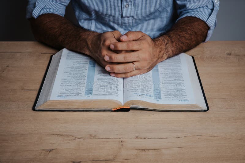 Hands of a Man Praying Over a Bible Stock Image - Image of christ ...
