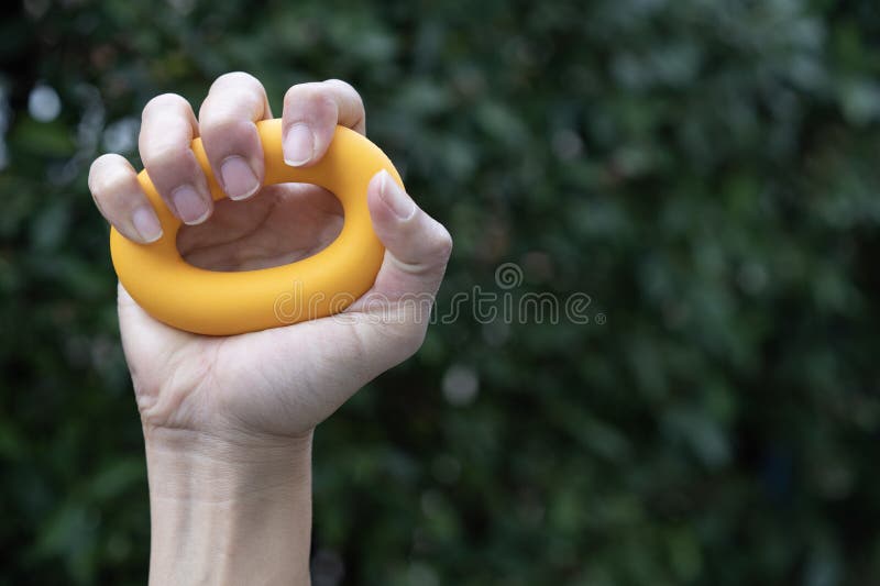 Hands of a Man Squeezing a Green Stress Ball Stock Image - Image of pressure, concept: 281568767
