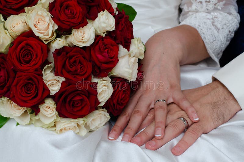 Hands of Married Couple with Rings and Roses Stock Photo - Image of ...