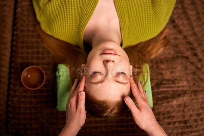 Hands Of Masseuse Making Manual Massage Of Head To Beautiful Client