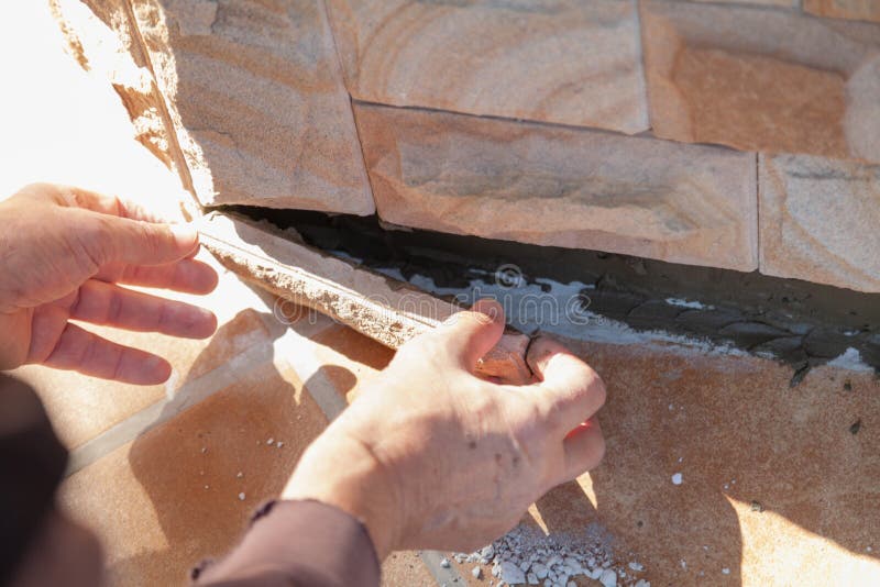 Hands of Master Apply Tiles on Wall of House Stock Image - Image of ...