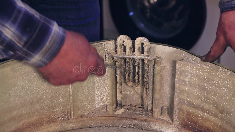 The Hands of the Master Clean the Heating Element from Plaque. Stock ...
