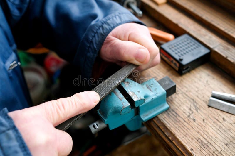 The Hands of the Master Hold the File. Workplace, Clamp Visible, Vice ...