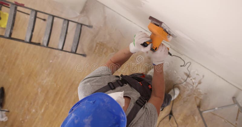 Hands of Master Removing Plaster from Wall Using Grinder Stock Footage ...