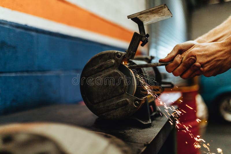 Mechanic Grinding a Car Part on Bench Grinder Stock Photo - Image of ...