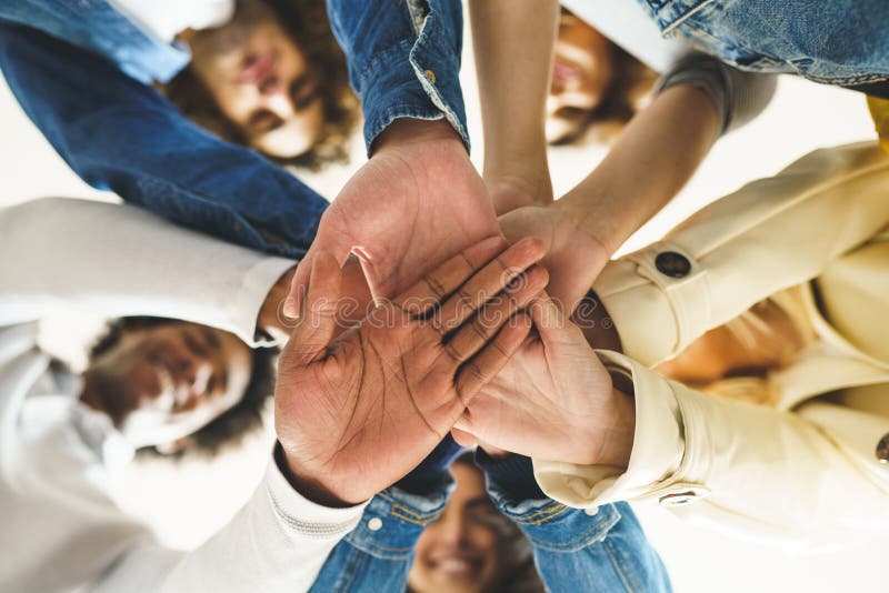 Hands of a Multi-ethnic Group of Friends Joined Together As a Sign of ...