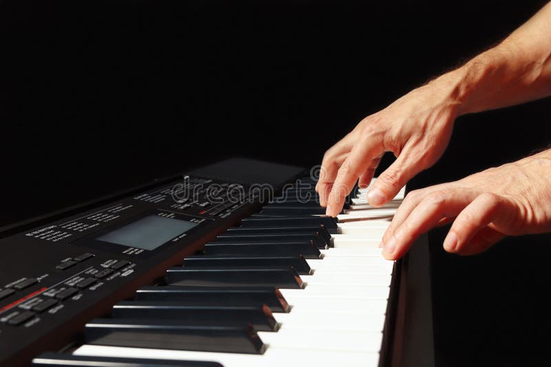 Hands of Musician Play the Keys of the Electronic Synth on Black ...