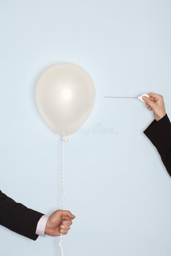 Hands with Needle and Balloon Against Blue Background Stock Image ...