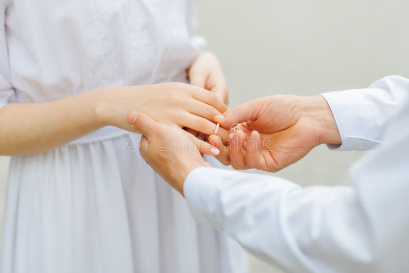 Hands of the Newlyweds. a Man Hand Puts on a Ring. Wedding Ceremony ...