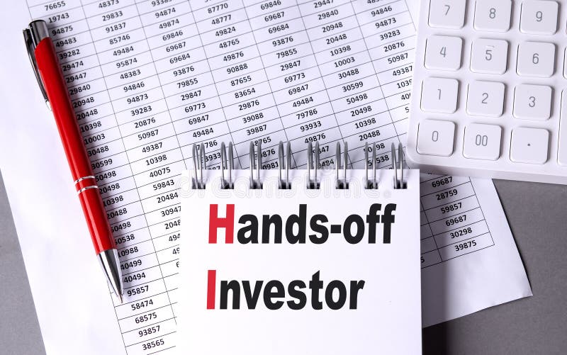 HANDS-OFF INVESTOR Text on Notebook with Chart , Pen and Calculator ...