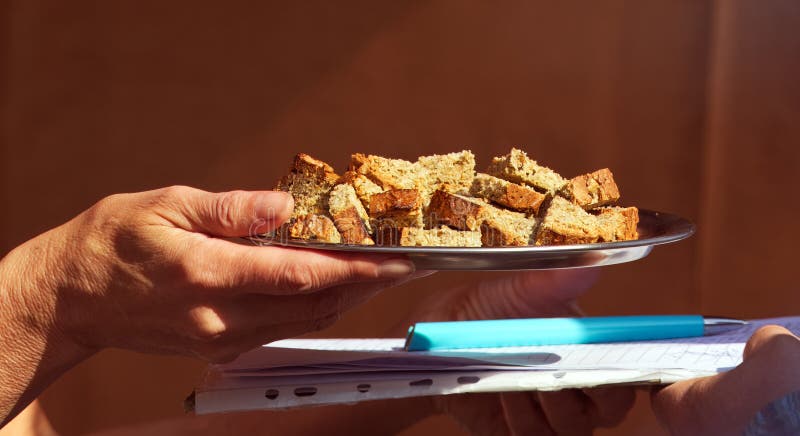 Hands Offering Small Bread Pieces on a Plate Stock Image - Image of ...