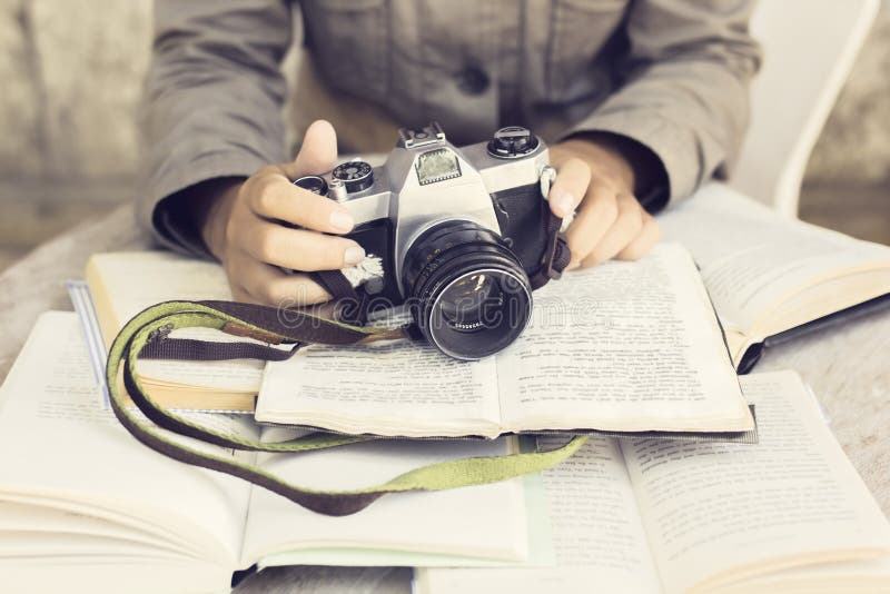 Hands with Old Camera and Several Open Books Stock Photo - Image of ...