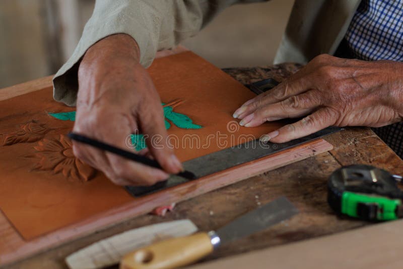 Hands of an Older Man, Working on Embossed Leather, and Taking Notes ...