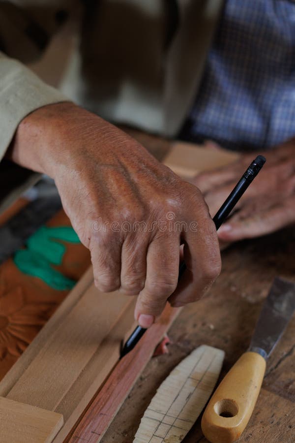 Hands of an Older Man, Working on Embossed Leather, and Taking Notes ...