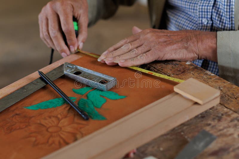 Hands of an Older Man, Working on Embossed Leather, and Taking Notes ...