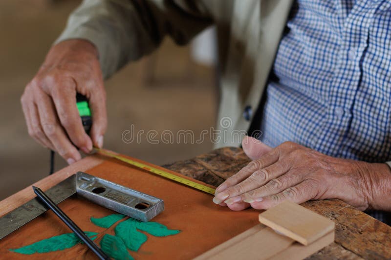 Hands of an Older Man, Working on Embossed Leather, and Taking Notes ...