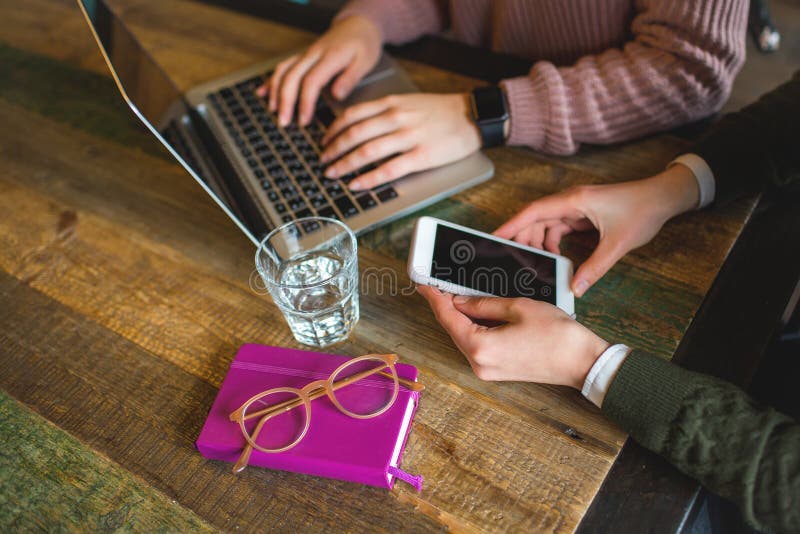 Hands Over Laptop and Smartphone on Wooden Table with Glasses Stock ...