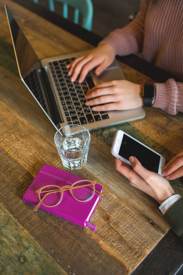 Hands Over Laptop and Smartphone on Wooden Table with Glasses Stock ...