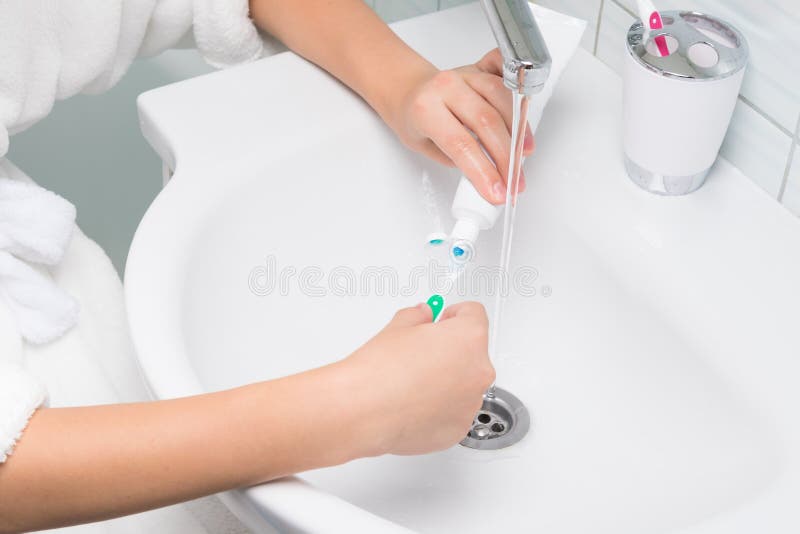 Hands Over the Sink Apply Toothpaste To the Brush, Top View Close-up ...