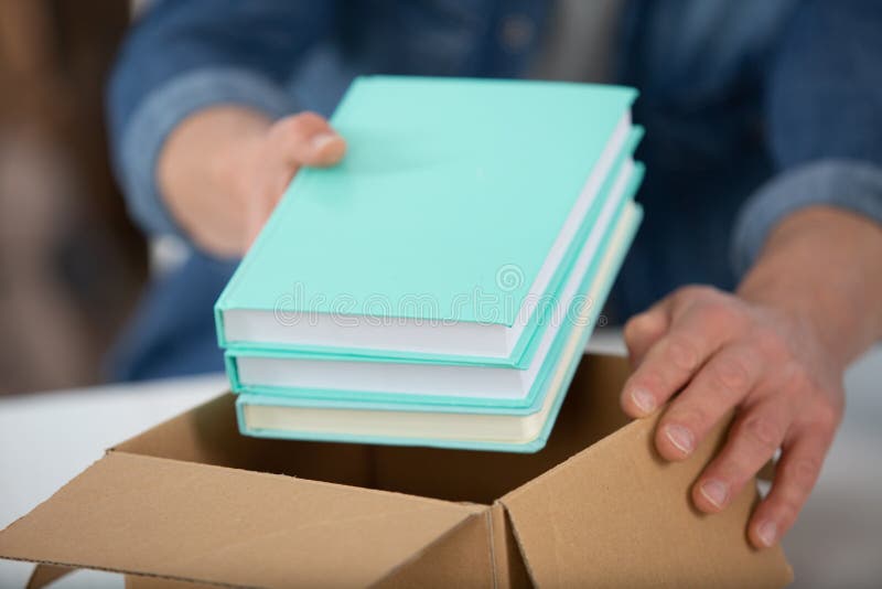 Hands Packing Books into Box Stock Photo - Image of heterosexualcouple ...