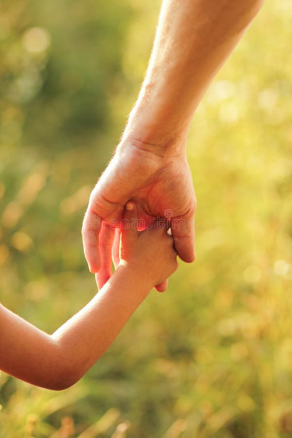 Hands of Parent and Child Outdoors in the Park Stock Photo - Image of ...