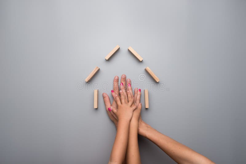 Hands of Parents and Two Children Inside the Framework of a House Stock ...