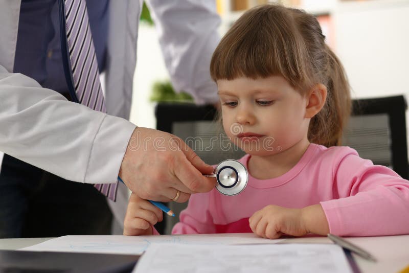 Hands of Pediatrician Doctor Examining Small Child with Stethoscope ... Hands of Pediatrician Doctor Examining Small Child with Stethoscope ...