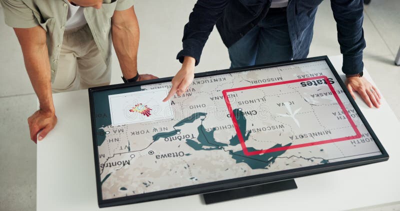 Hands, People and Interactive Display with Map in Office of Global ...