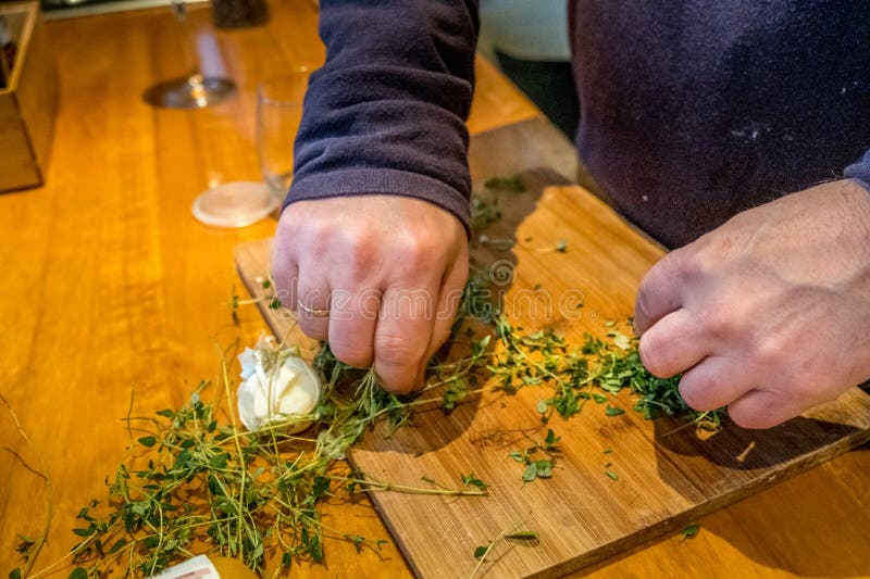 Hands of a Person Sorting Out Herbs on a Kitchen Table Stock Image ...