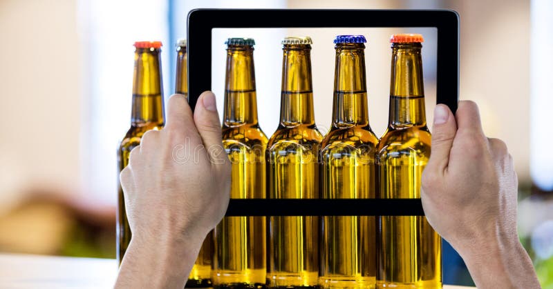 Hands Photographing Beer Bottles through Digital Tablet at Bar Stock ...