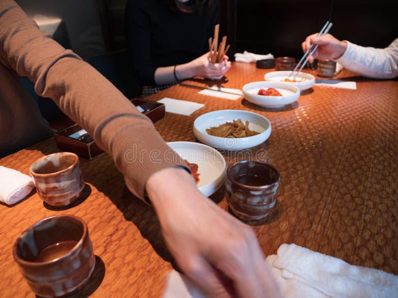 Hands Picking at Side Dishes in a Korean Restaurant Stock Photo - Image ...