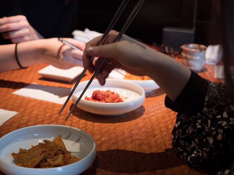 Hands Picking at Side Dishes in a Korean Restaurant Stock Image - Image ...