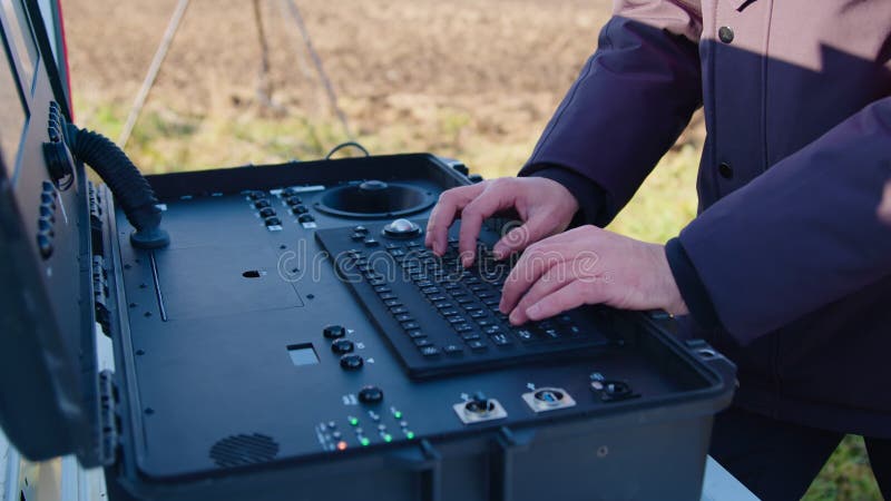 The Hands of a Piloting Specialist Pilot a Drone in Flight at a Control ...
