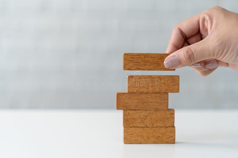 Hands are Placing Wooden Blocks on White Table for Strategy Plan. Risk ...