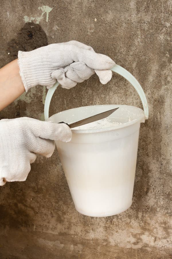 Hands of Plasterer Holding Bucket with Plaster and Spatula Stock Photo ...