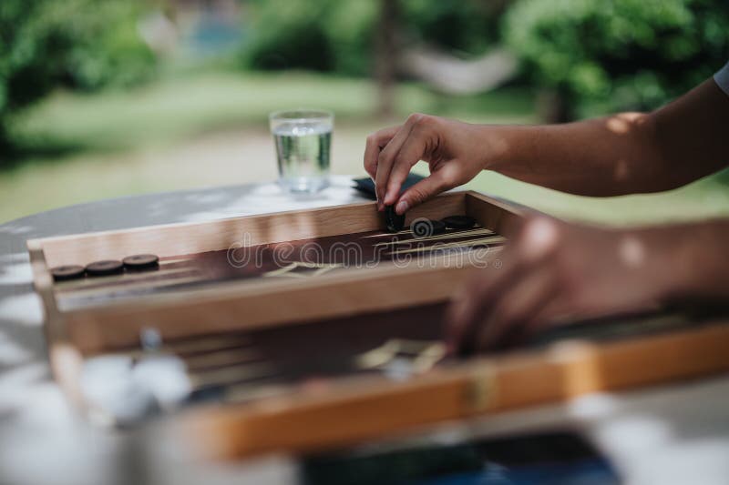 Hands Playing Backgammon Outdoors on a Sunny Day with Drinks Stock ...