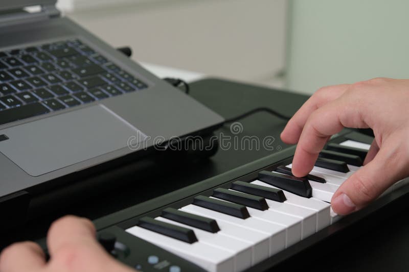 Hands Playing the Electronic Piano in Front of the Laptop Stock Photo ...
