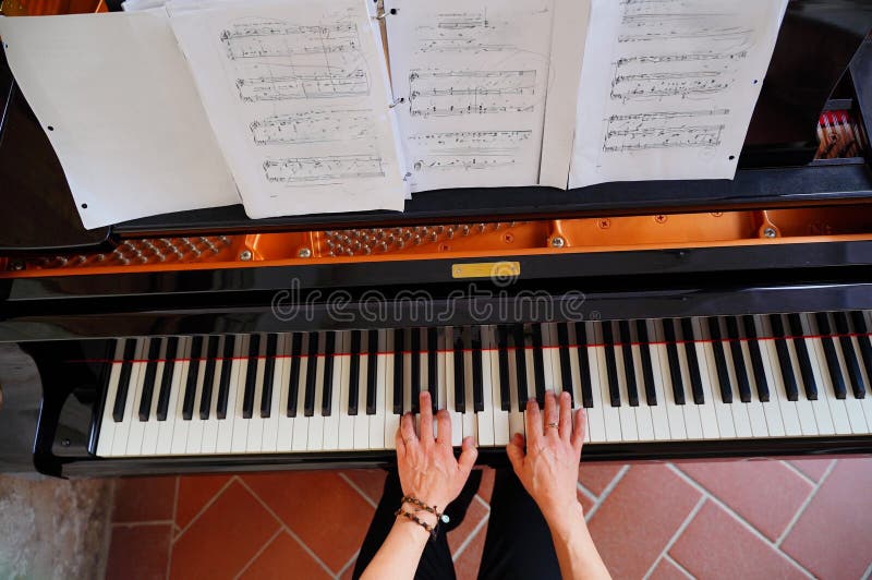 Hands Playing Piano with Sheet Music in View Stock Image - Image of ...