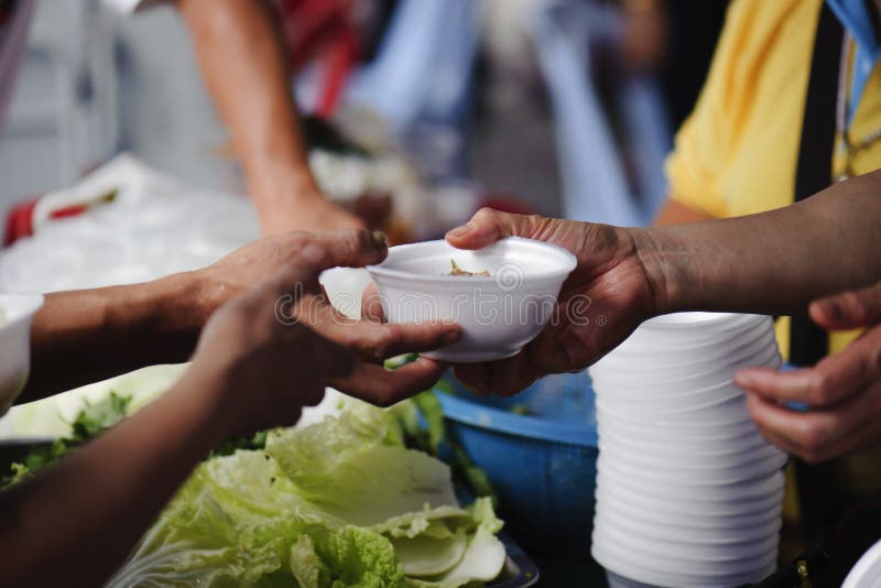 The Hands of the Poor Receive Food from the Philanthropist. Sharing ...