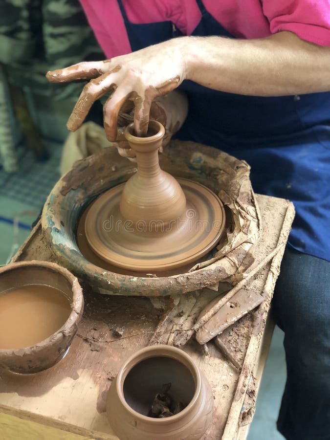 The Hands of the Potter Who Makes the Dishes from Brown Clay Stock ...
