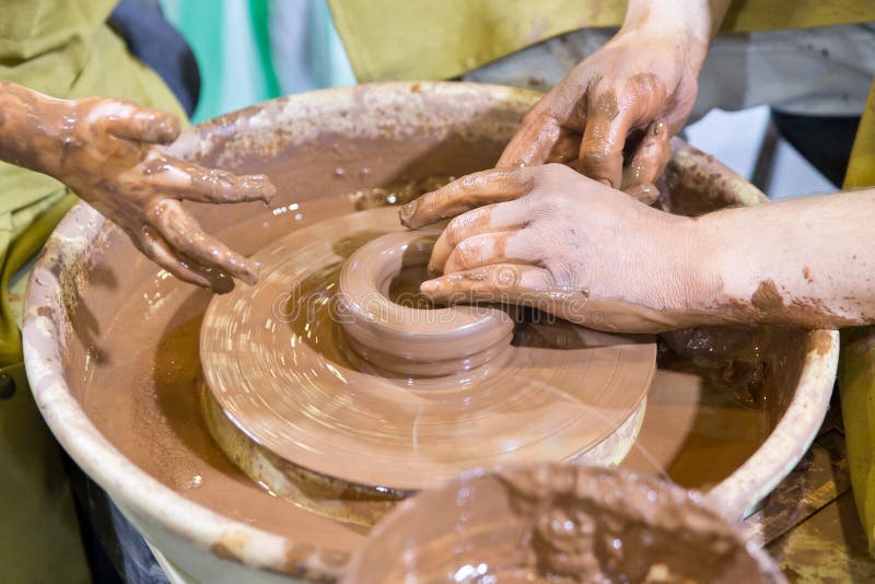 Hands on a Pottery Wheel. Clay Potter Creating on the Pottery Wheel ...