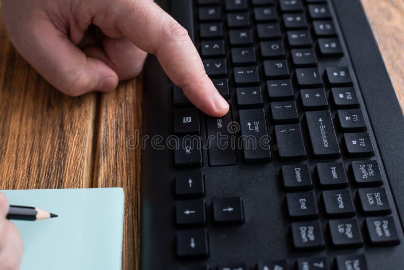 Hands Pressing Computer Keyboard Keys while Writing with Pencil in ...