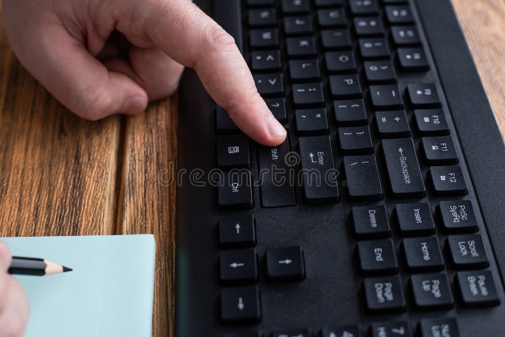 Hands Pressing Computer Keyboard Keys while Writing with Pencil in ...
