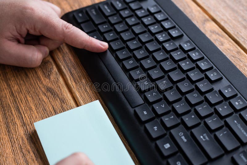 Hands Pressing Computer Keyboard Keys while Writing with Pencil in ...