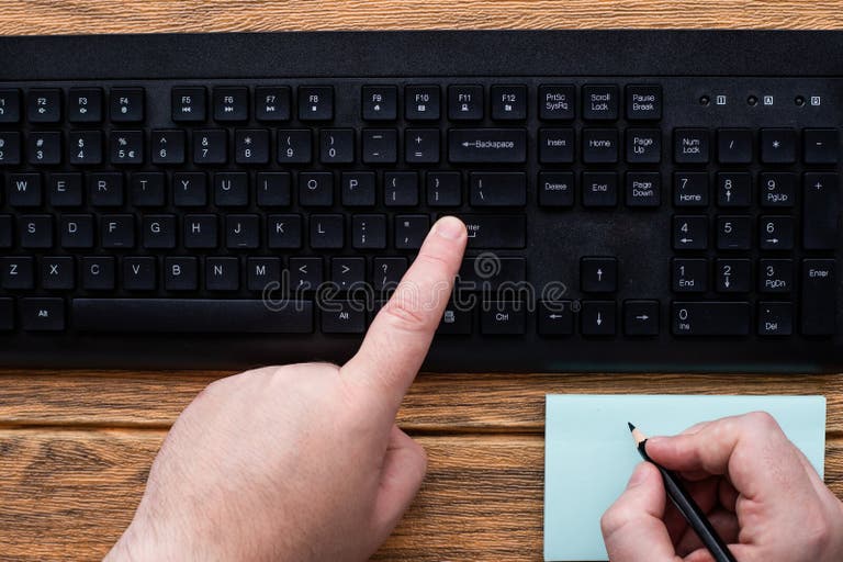 Hands Pressing Computer Keyboard Keys while Writing with Pencil in ...