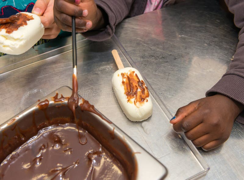 Hands of Primary School Children Putting Chocolate on Ice Cream Stock ...