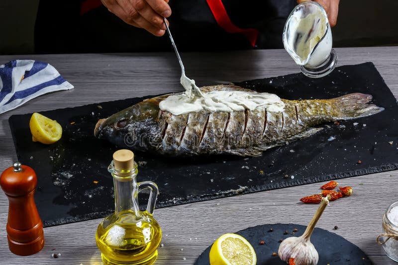 Hands in the Process of Cooking Fish. of Making Fish Sauce. Top View ...