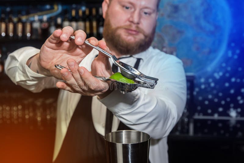 Hands of a Professional Bartender Squeeze Lime Juice with an Iron Tool ...
